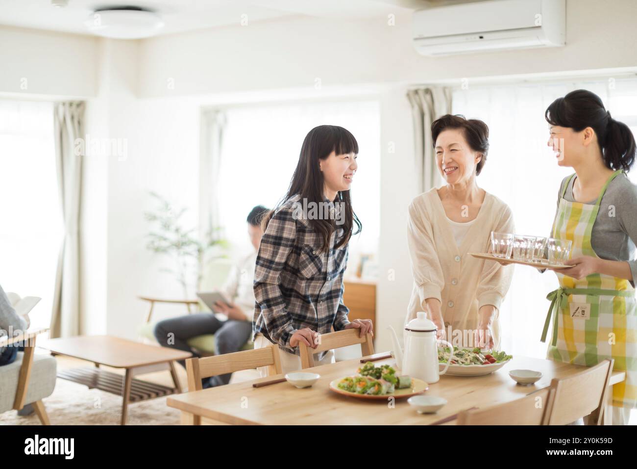 Three generations of a family preparing food Stock Photo - Alamy