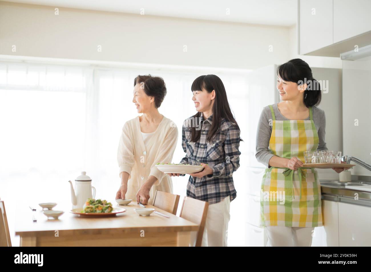 Three generations of a family preparing food Stock Photo - Alamy