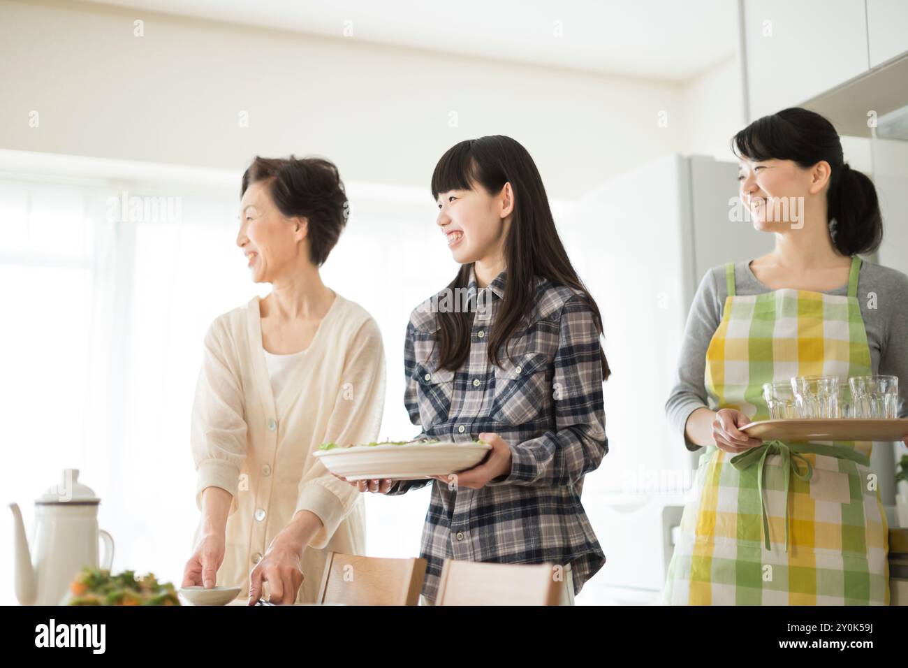Three generations of a family preparing food Stock Photo - Alamy