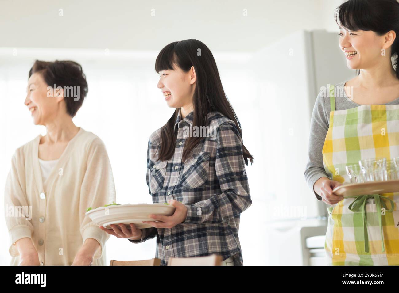 Three generations of a family preparing food Stock Photo - Alamy