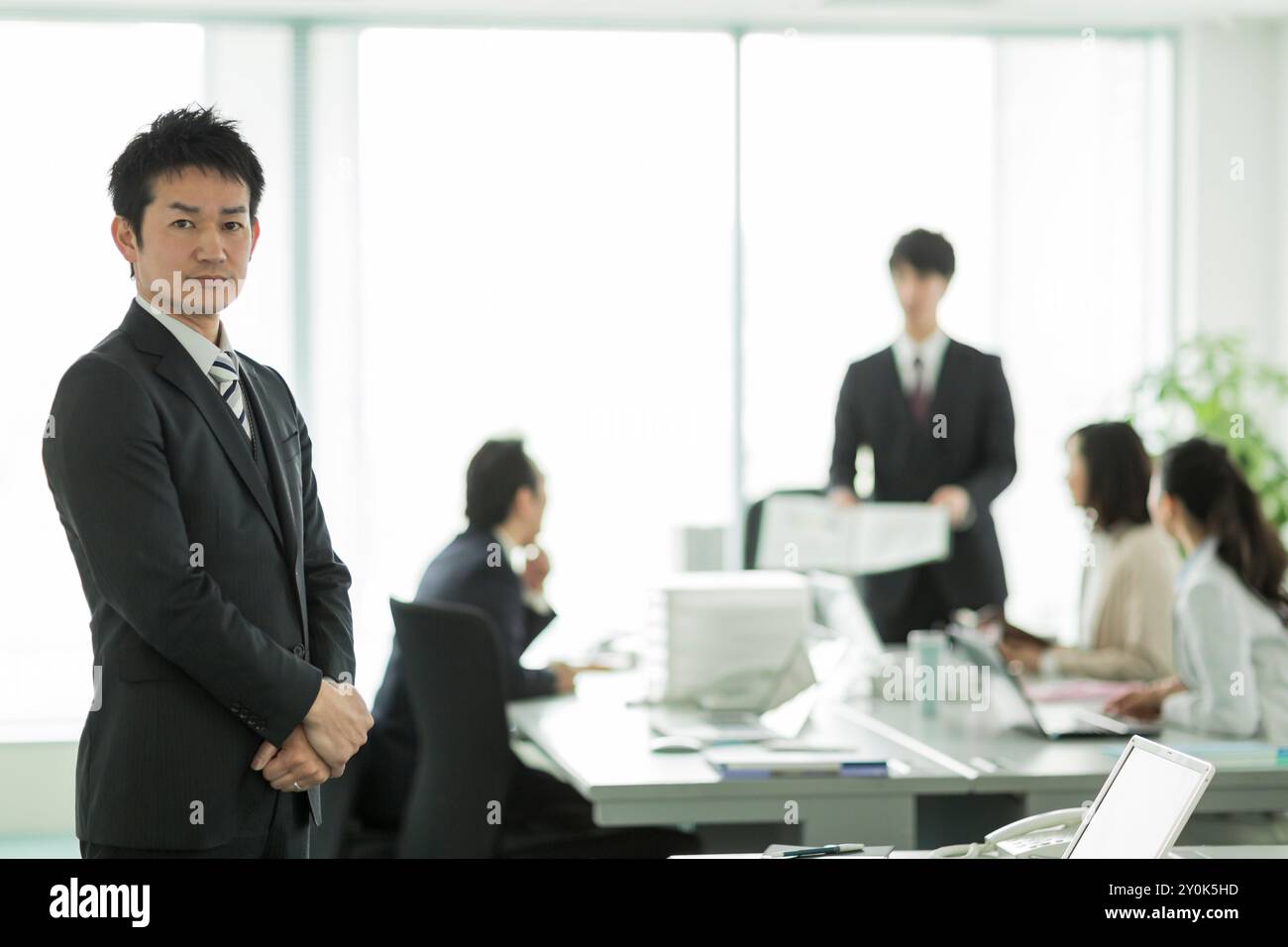 Japanese businessman standing at the office Stock Photo - Alamy