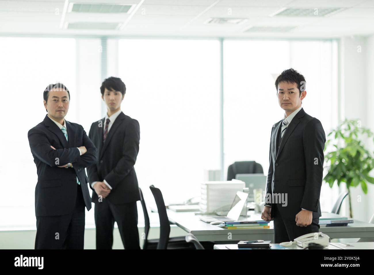 Three Japanese businessmen standing at the office Stock Photo - Alamy