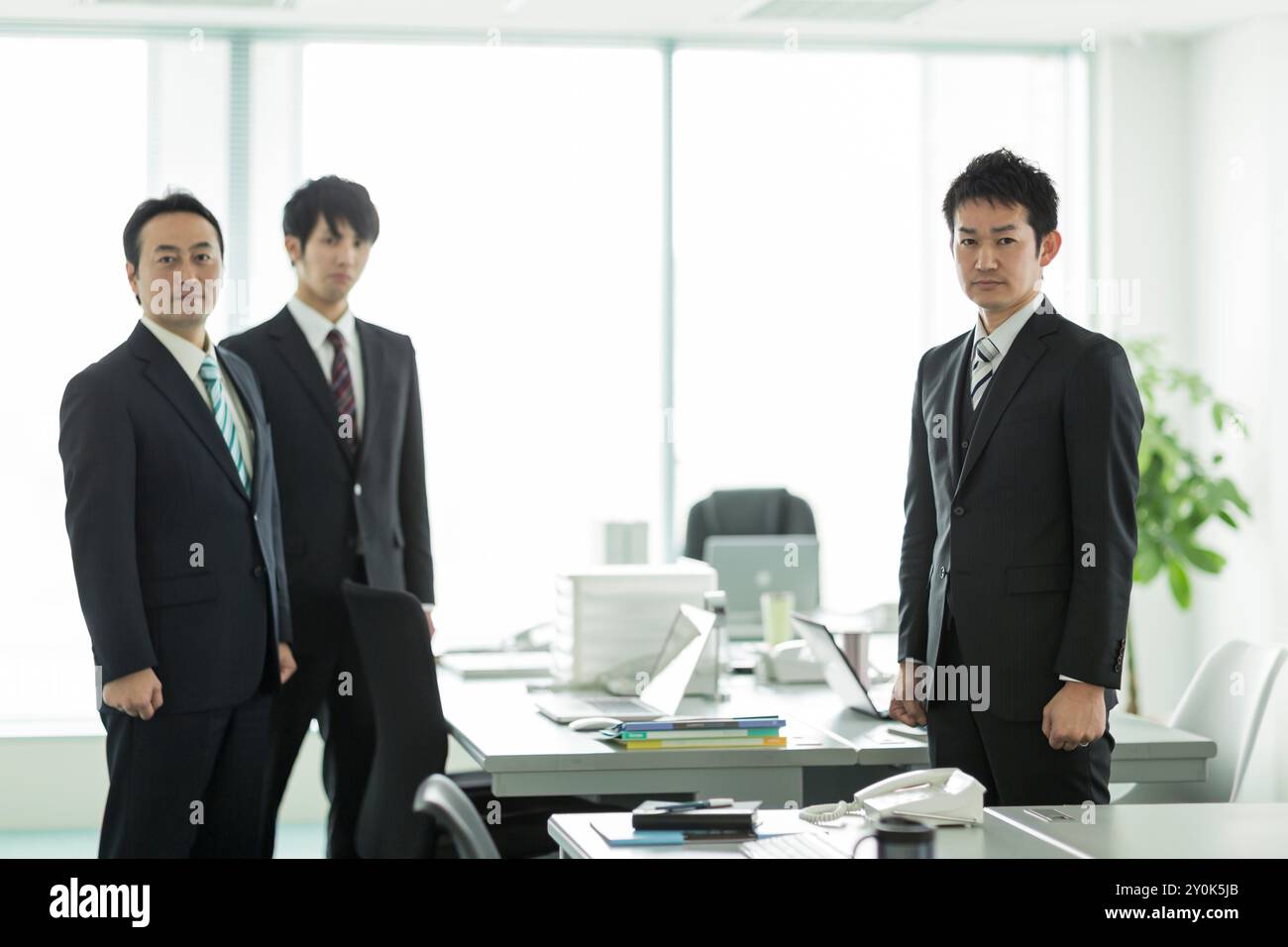 Three Japanese businessmen standing at the office Stock Photo - Alamy