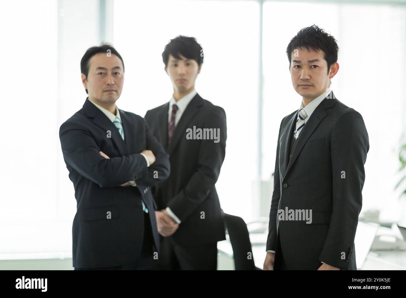 Three Japanese businessmen standing at the office Stock Photo - Alamy
