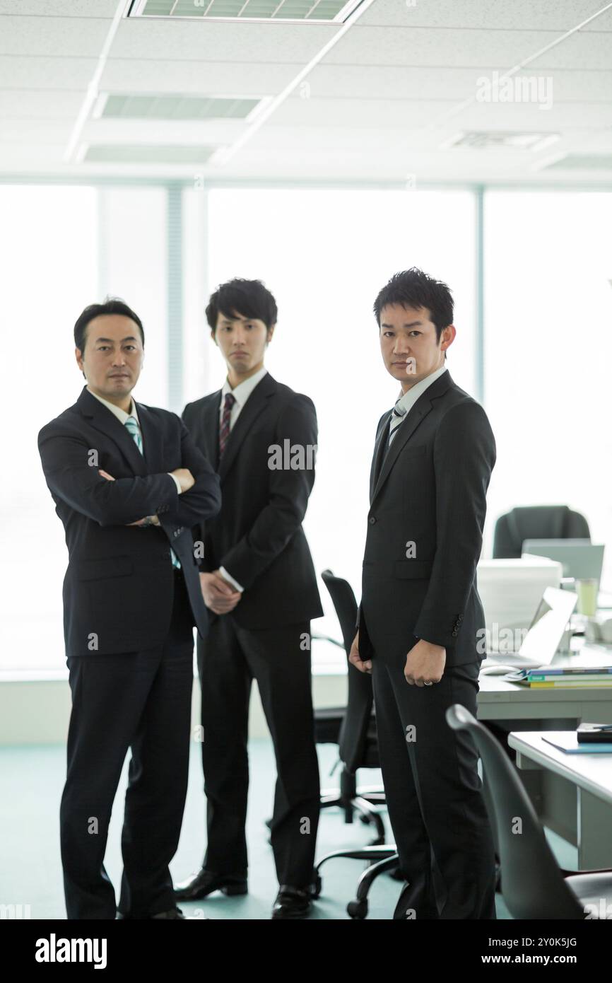Three Japanese businessmen standing at the office Stock Photo - Alamy