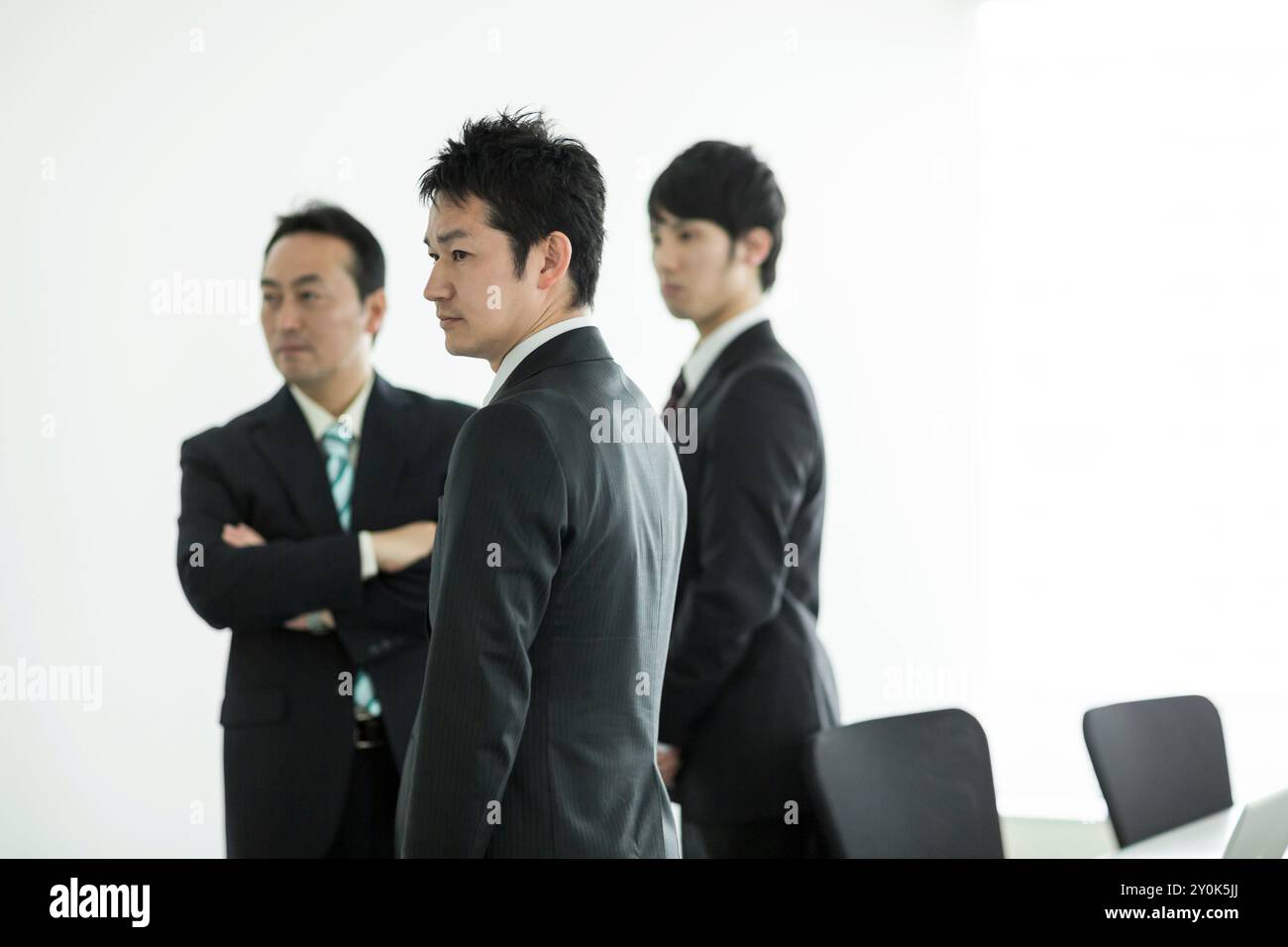 Three Japanese businessmen standing at the office Stock Photo - Alamy