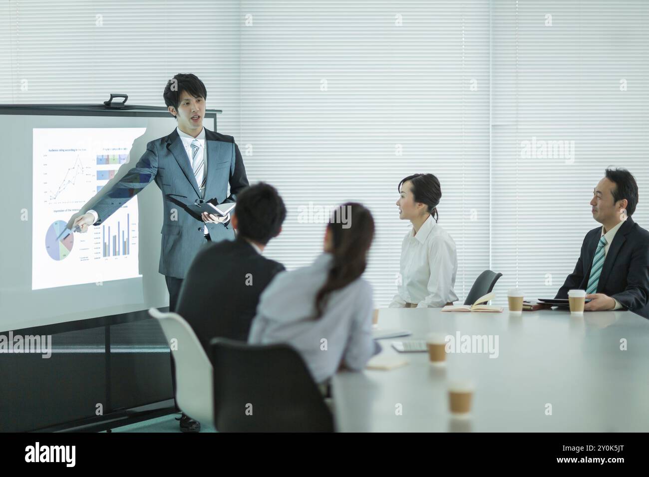 The businessman who explains at the meeting which uses a projector ...