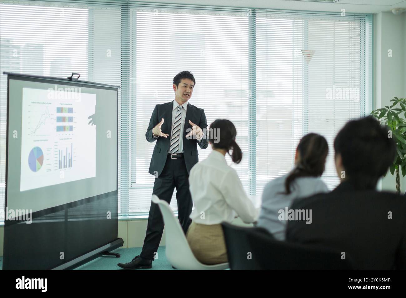 The businessman who explains at the meeting which uses a projector ...