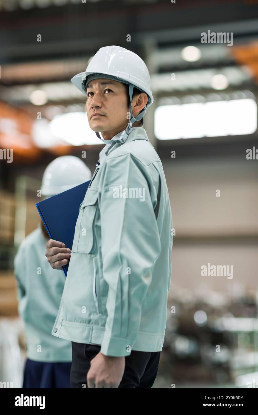 Worker man?looking back Stock Photo - Alamy