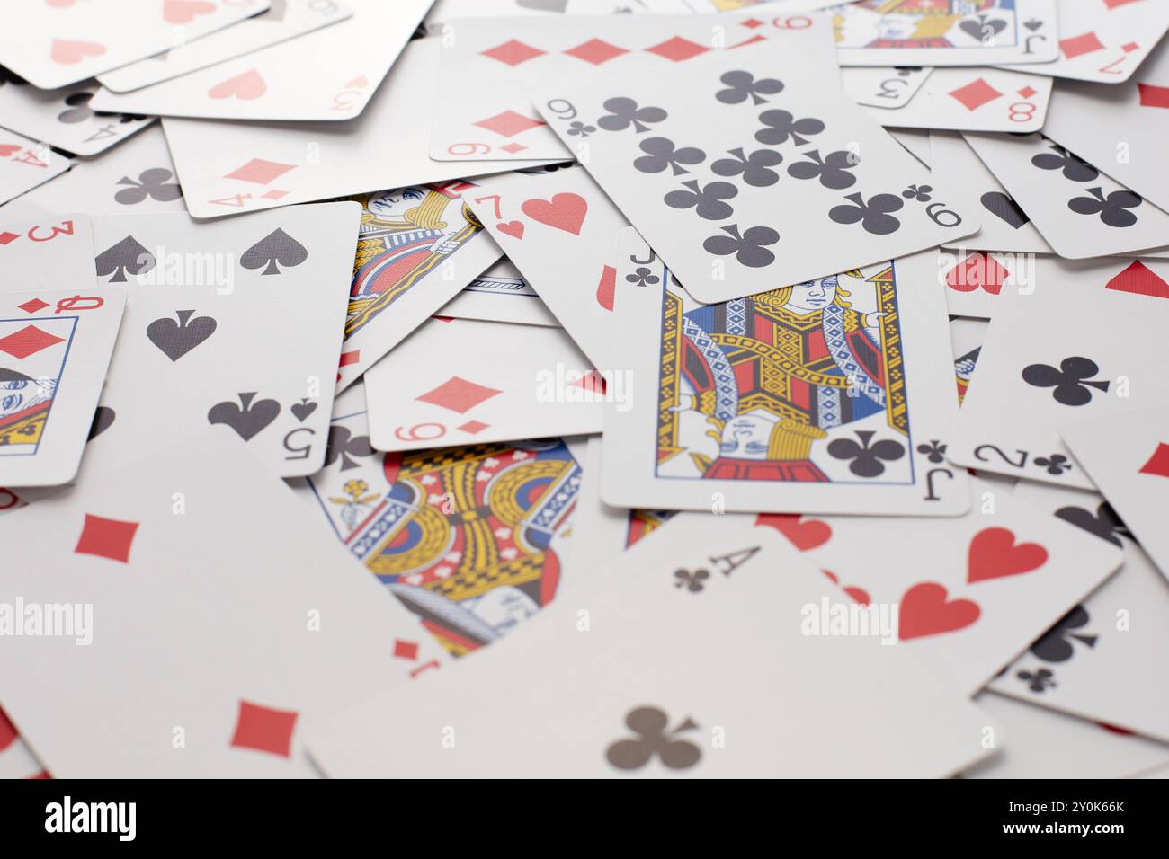 Playing cards scattered all around Stock Photo - Alamy