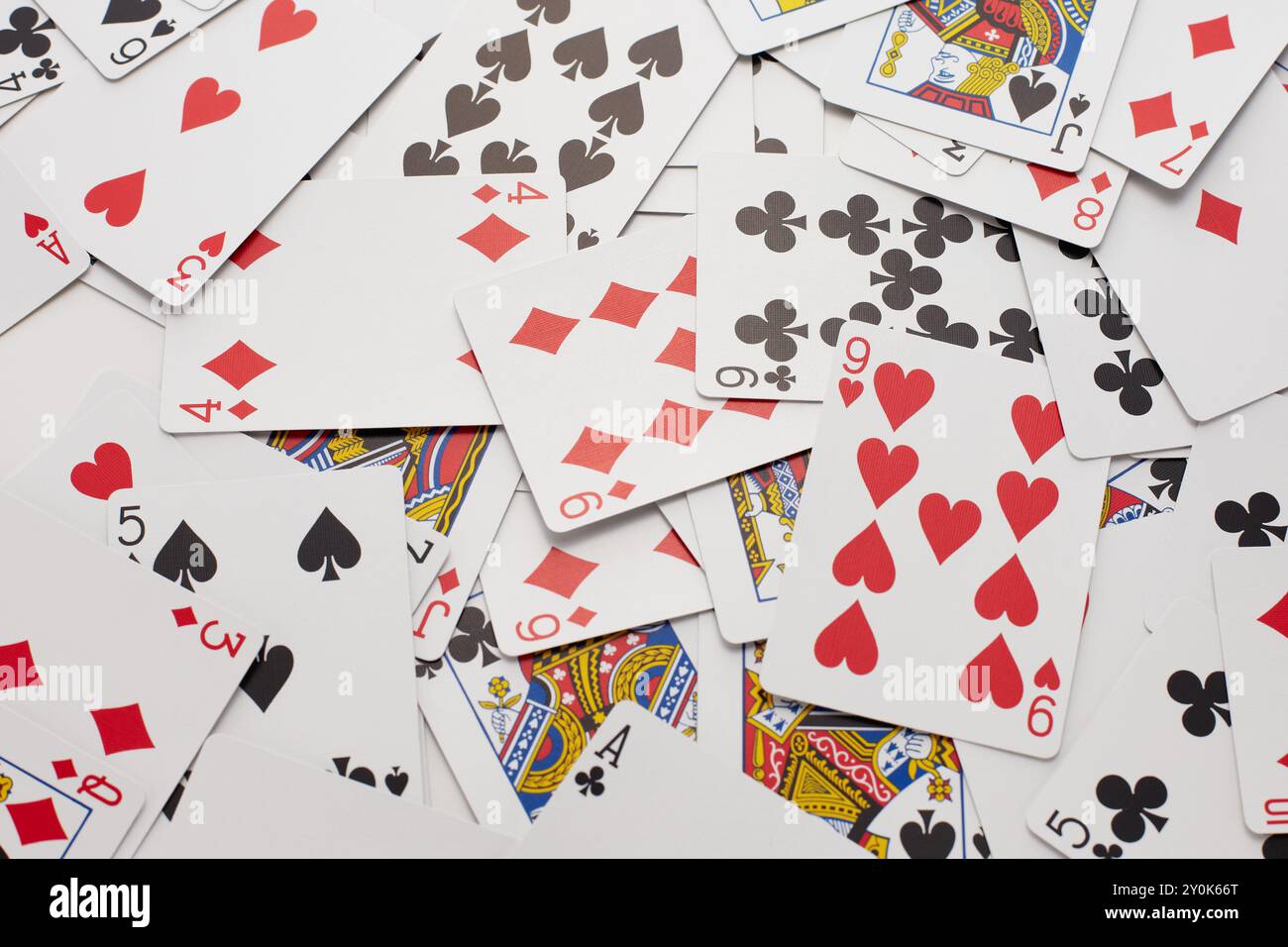 Playing cards scattered all around Stock Photo - Alamy
