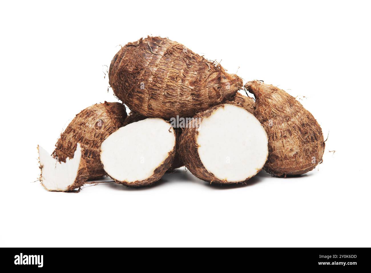 Close-up of fresh taro roots on a white background, with some roots cut ...