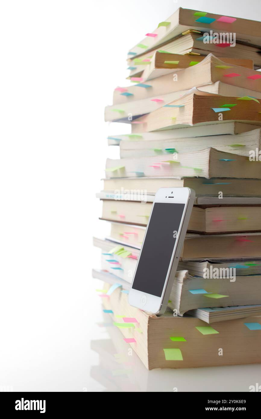 Smart phone and book with a lot of post it notes Stock Photo - Alamy