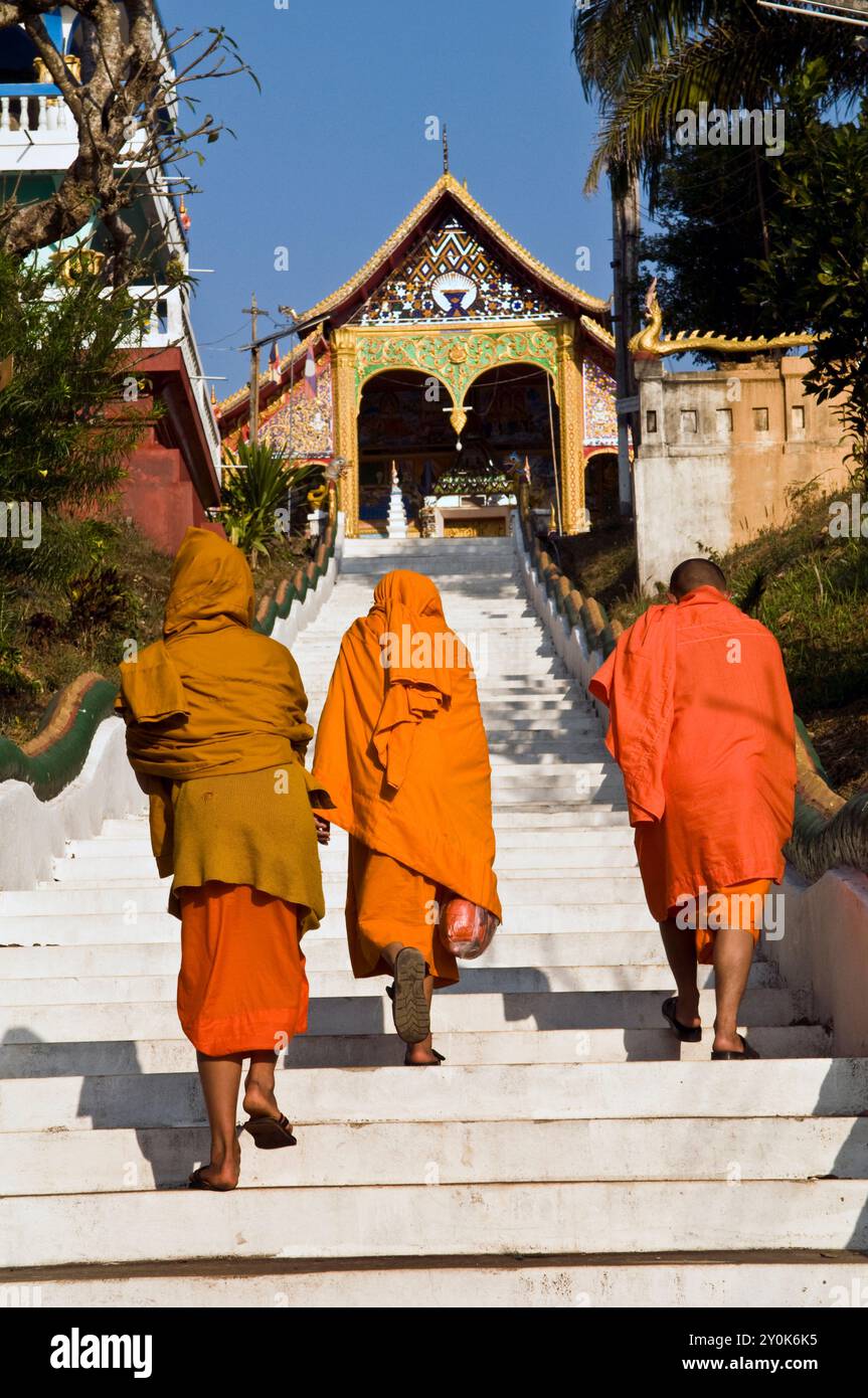 Monks climb up the stairs to the Buddhist temple in the border town of ...