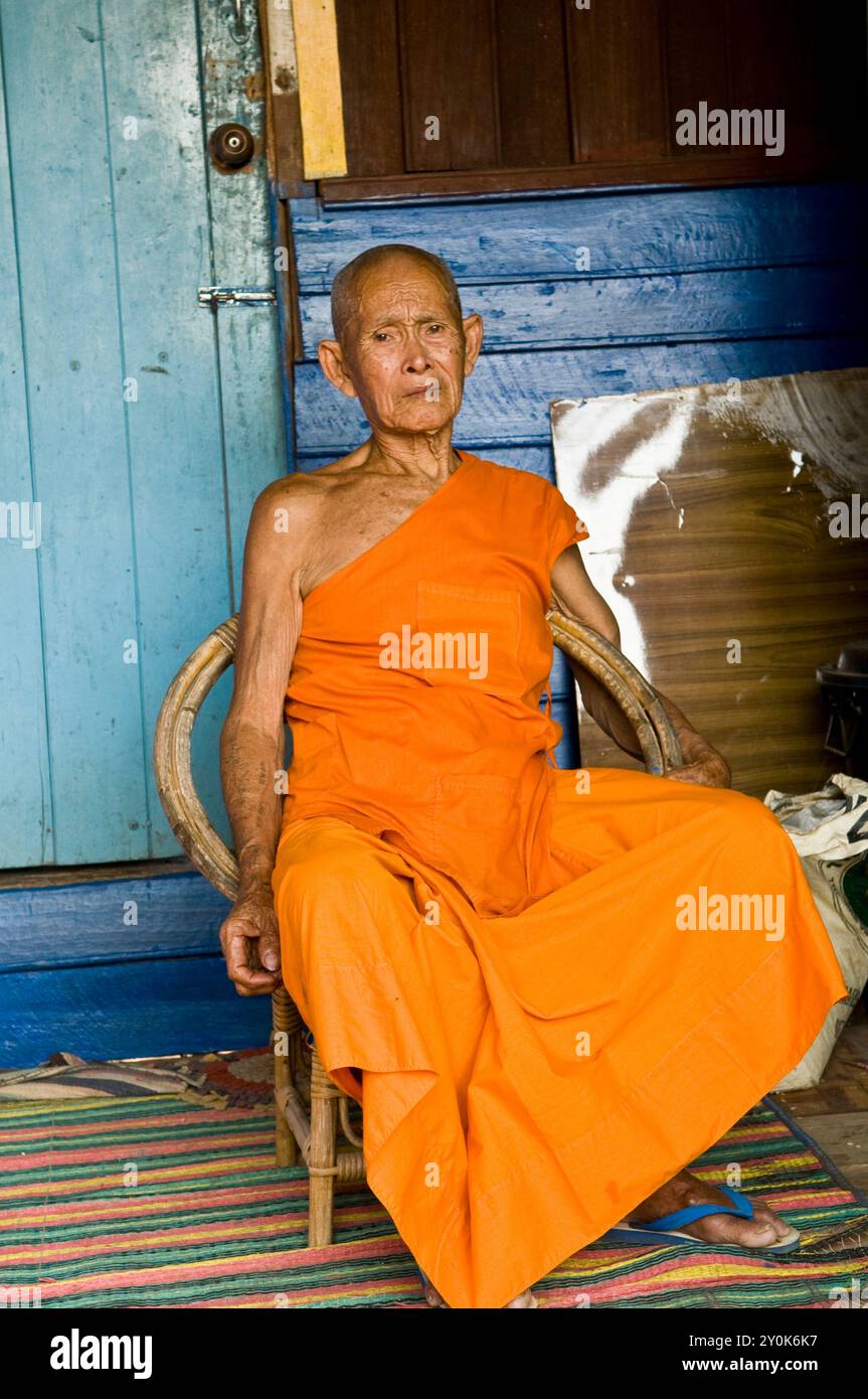 Portrait of an old Buddhist monk taken in the Buddhist temple in the ...