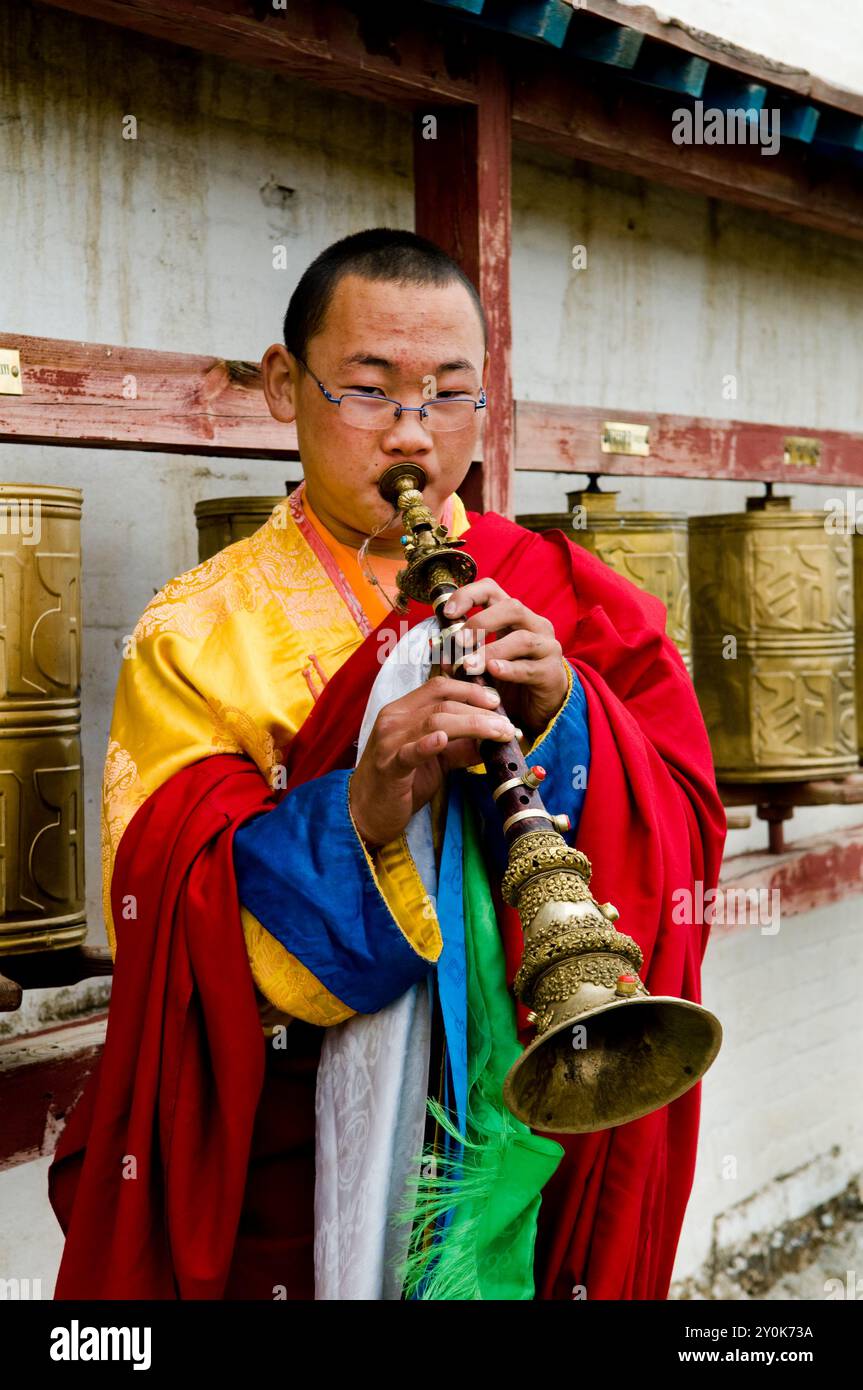 A Buddhisst monk playing a Gyaling musical instrument at the Erdene zuu ...