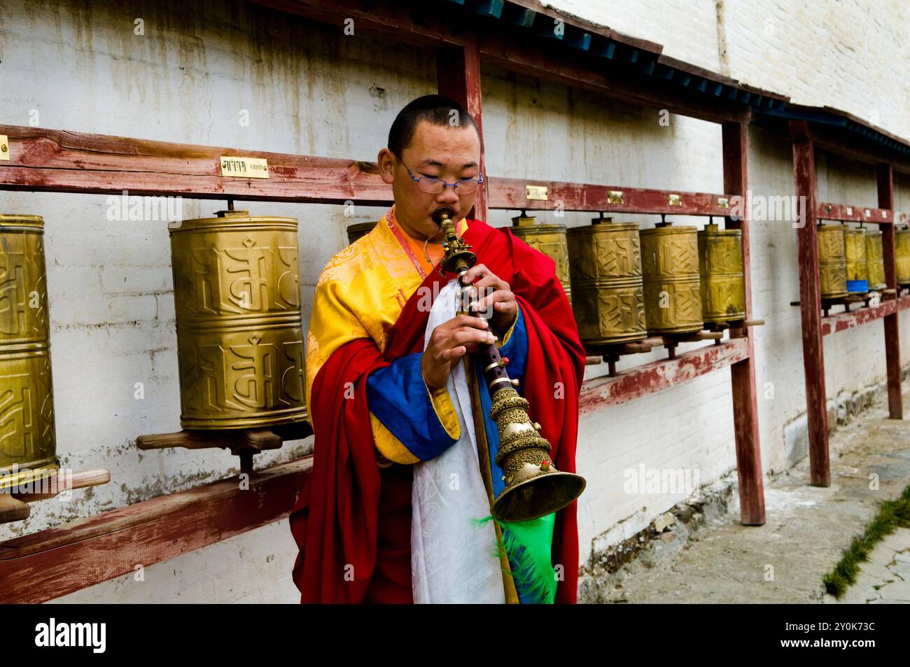 A Buddhisst monk playing a Gyaling musical instrument at the Erdene zuu ...