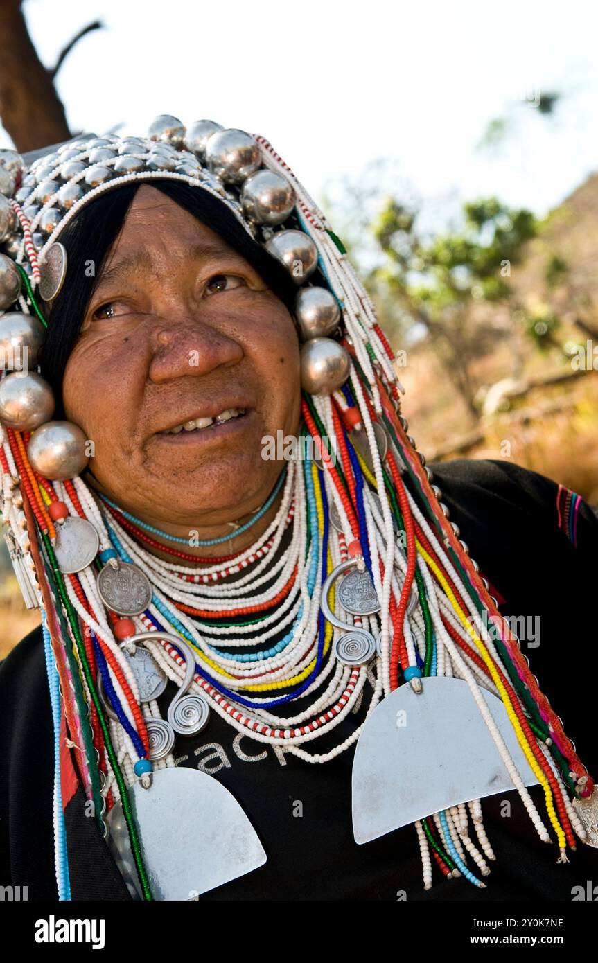 Portrait of an Akha woman wearing her traditional dress and head wear ...