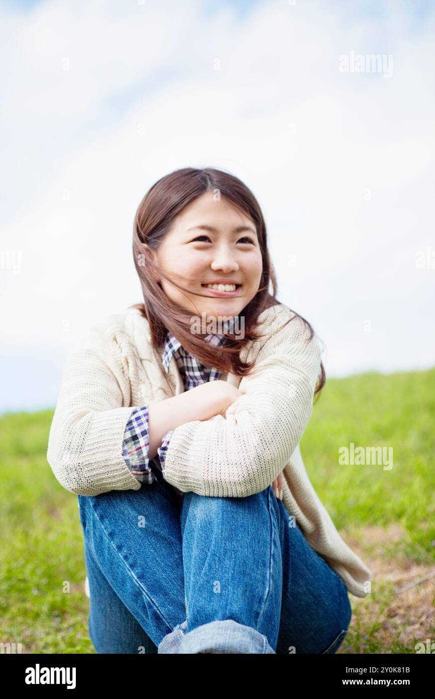 Smilling woman sitting on the bank Stock Photo - Alamy