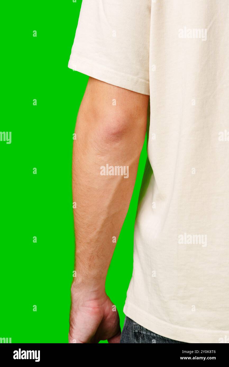 A Close-Up View of a Mans Hand Near His Pocket Against a Bright Green ...