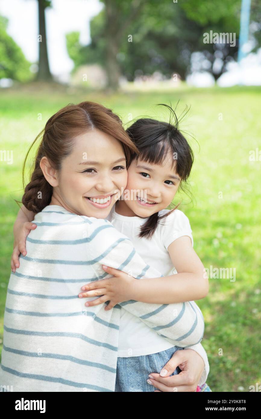 Mother hugging daughter Stock Photo - Alamy