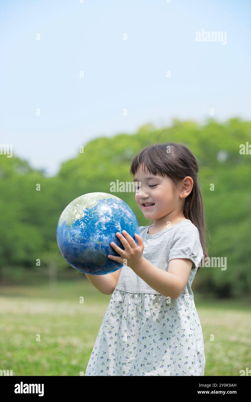 Girl watching the Earth Stock Photo - Alamy