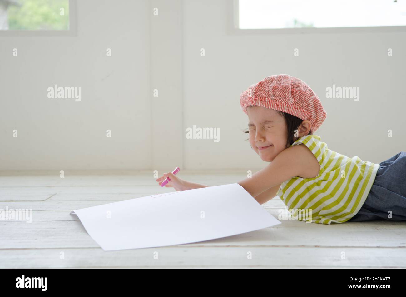 Girl lying on the floor with the face crumpled Stock Photo - Alamy