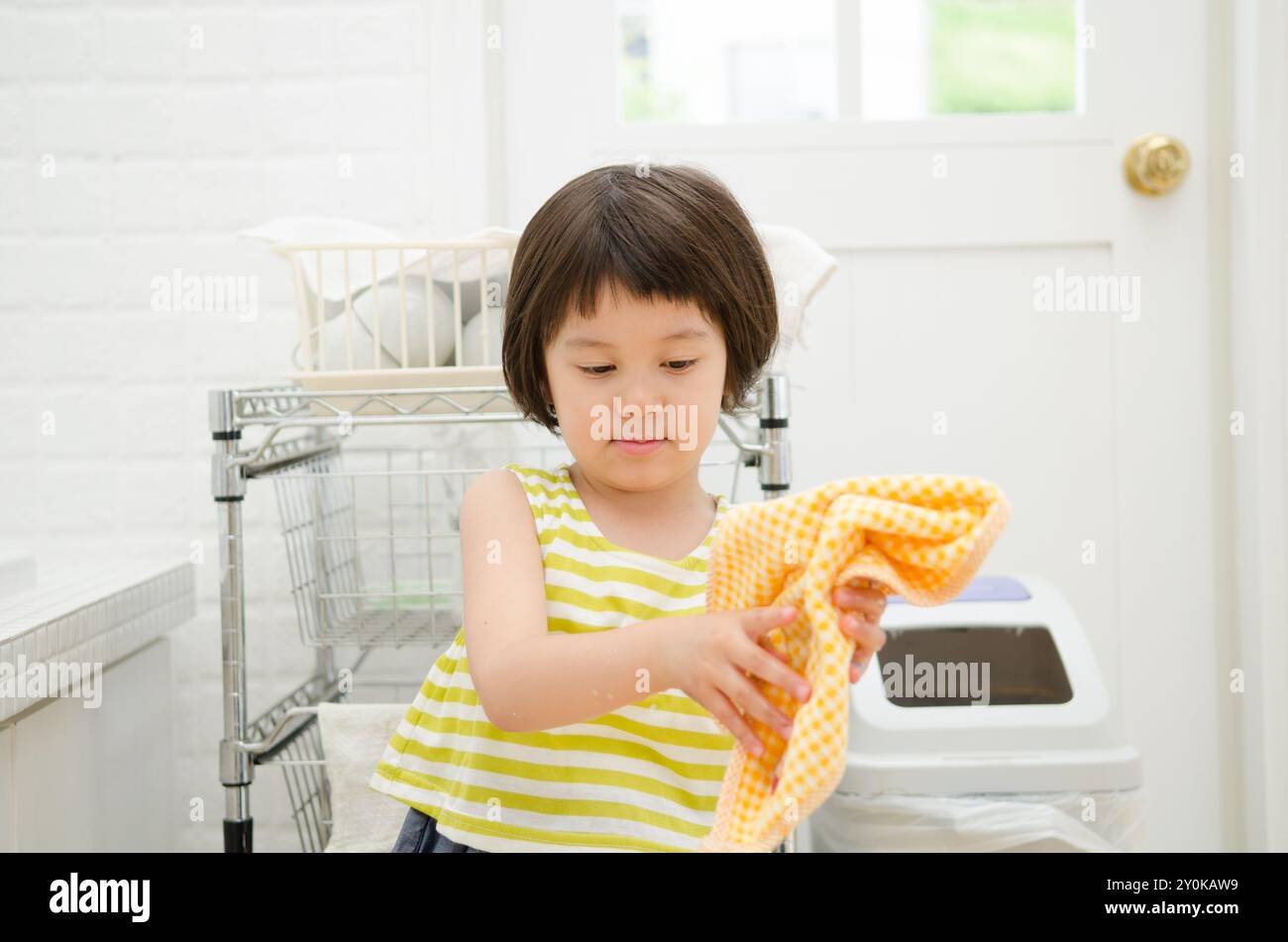 Girl wiping hands with a towel Stock Photo - Alamy