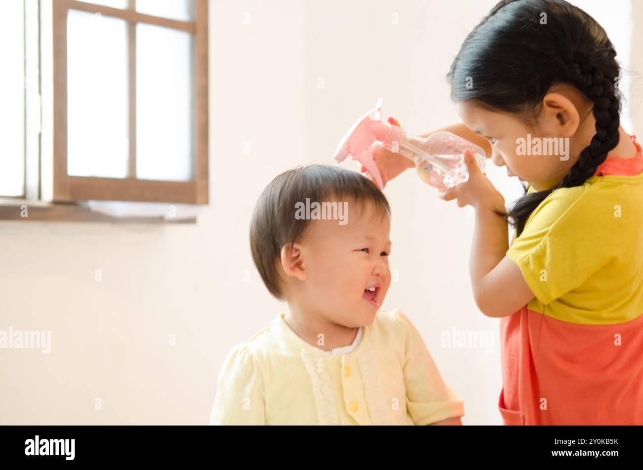 Sisters who are playing beauty parlor game Stock Photo - Alamy