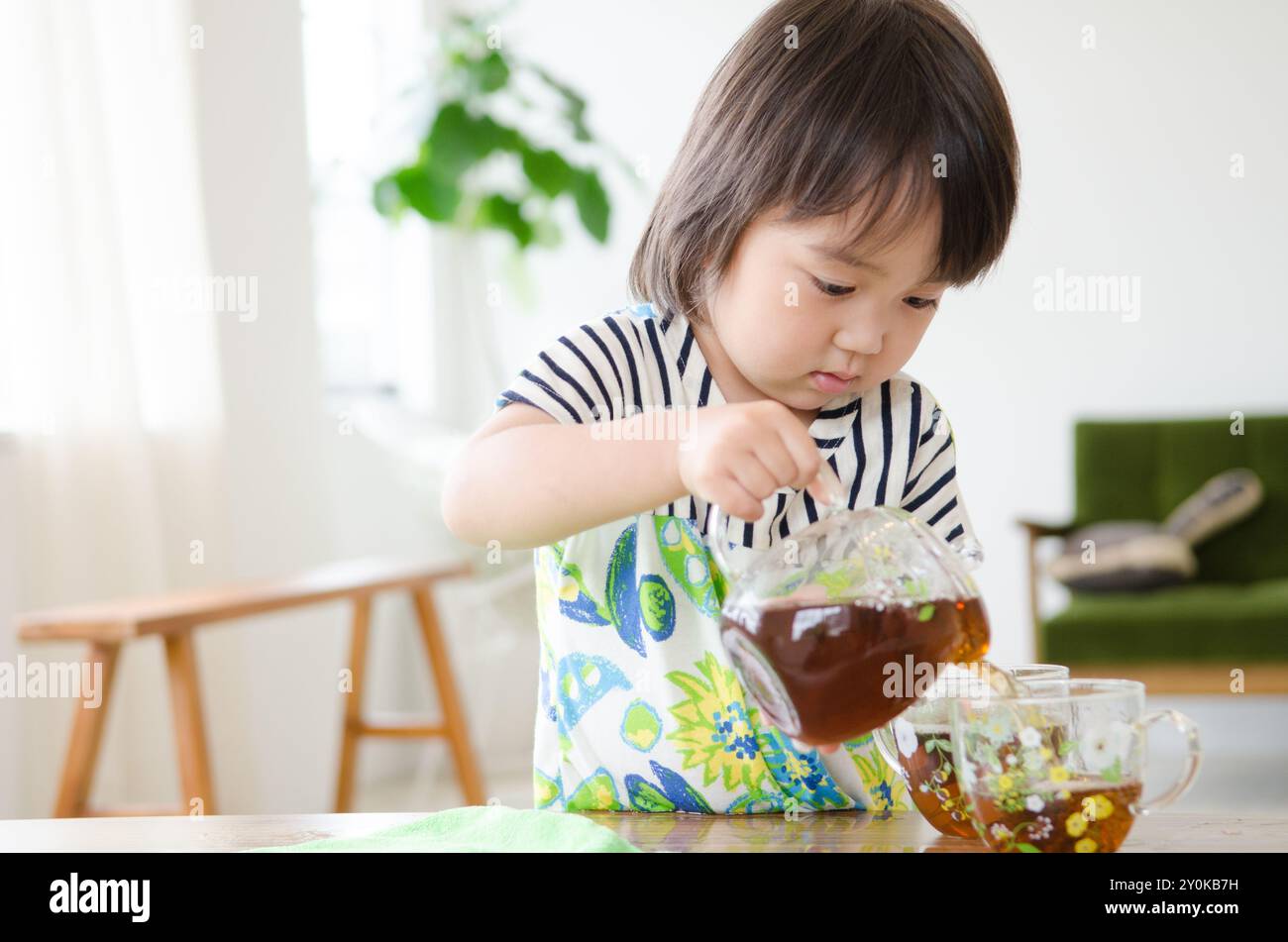 The boy who is pouring roasted barley tea Stock Photo - Alamy