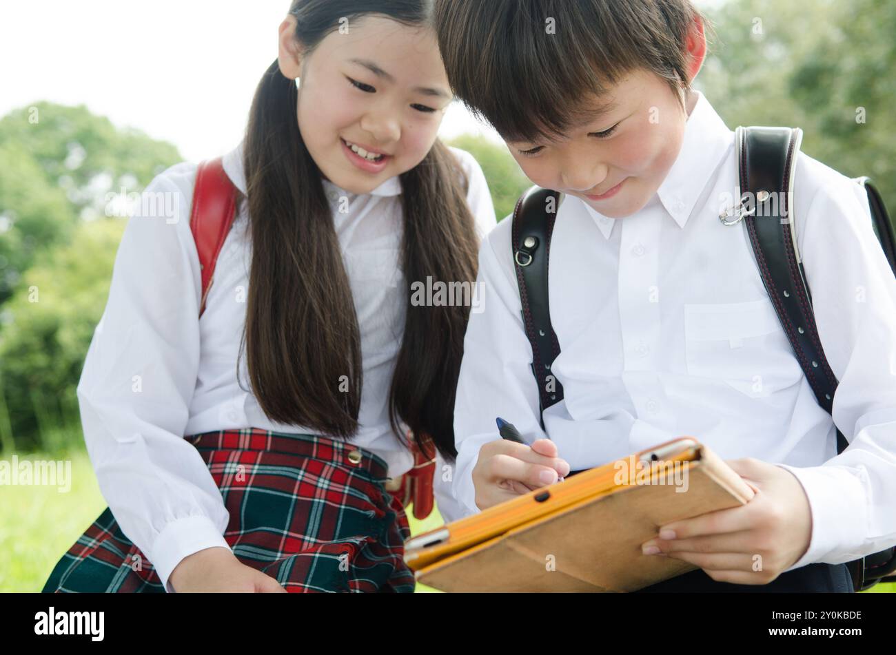 Two elementary school children studying on a tablet Stock Photo - Alamy
