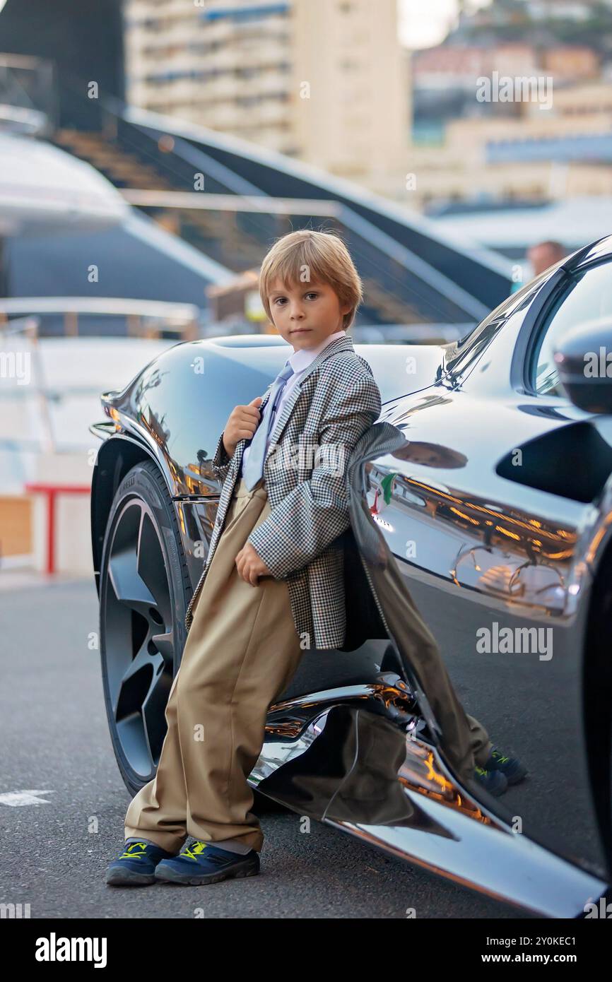 Beautiful fashion little boy, child in suit and tie, visiting Monaco ...