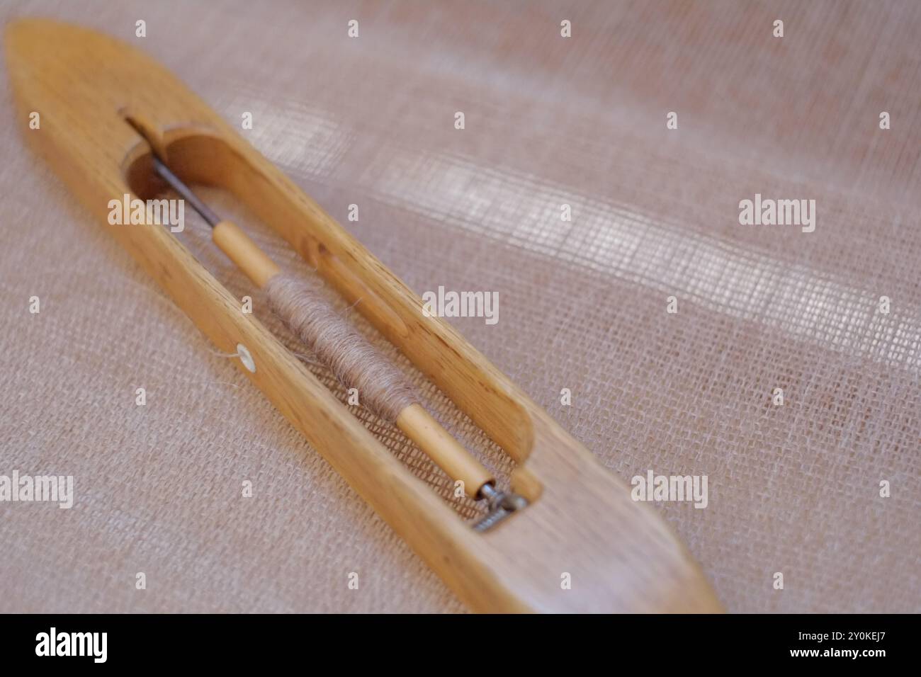 Woven textile and shuttle in the process of weaving Stock Photo - Alamy