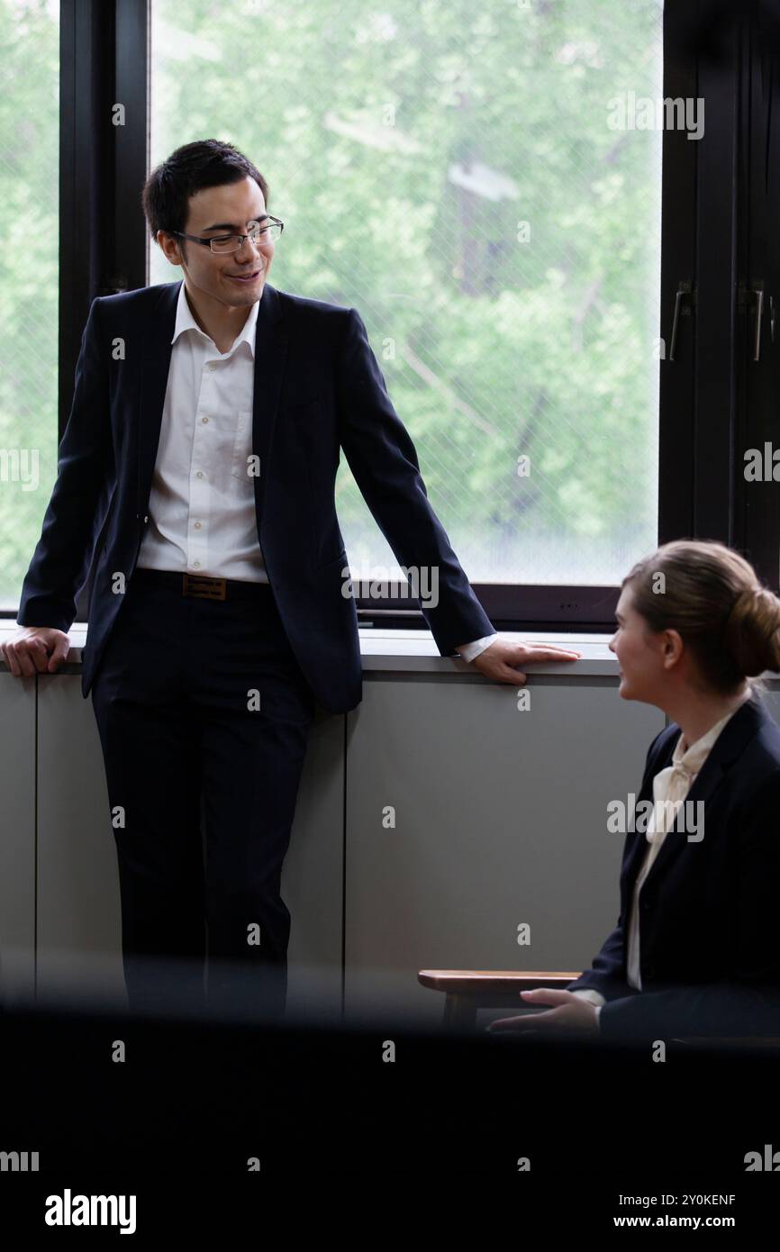 Business people talking by the window Stock Photo - Alamy