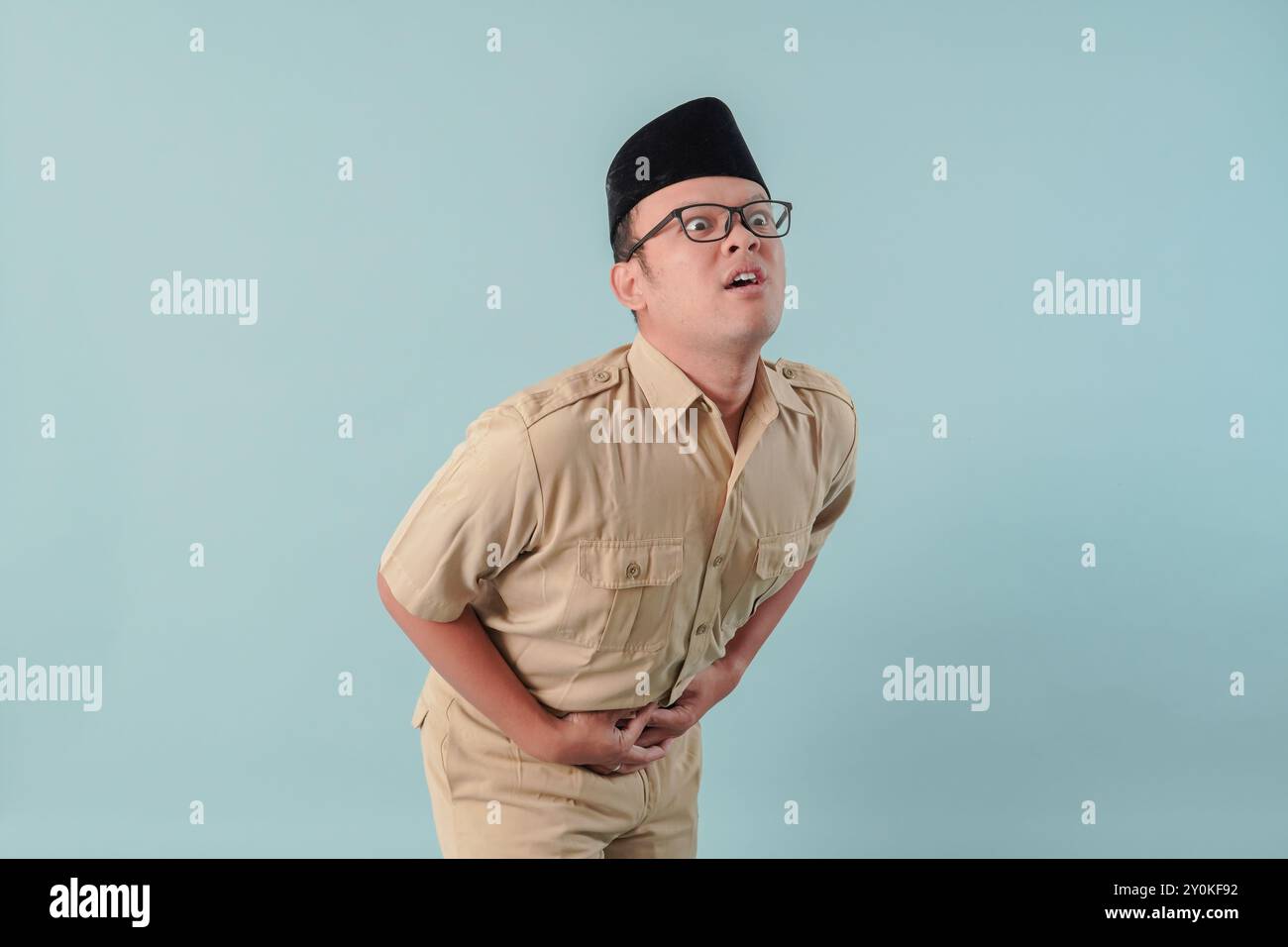 Unwell sick ill Indonesian government worker in khaki uniform is ...