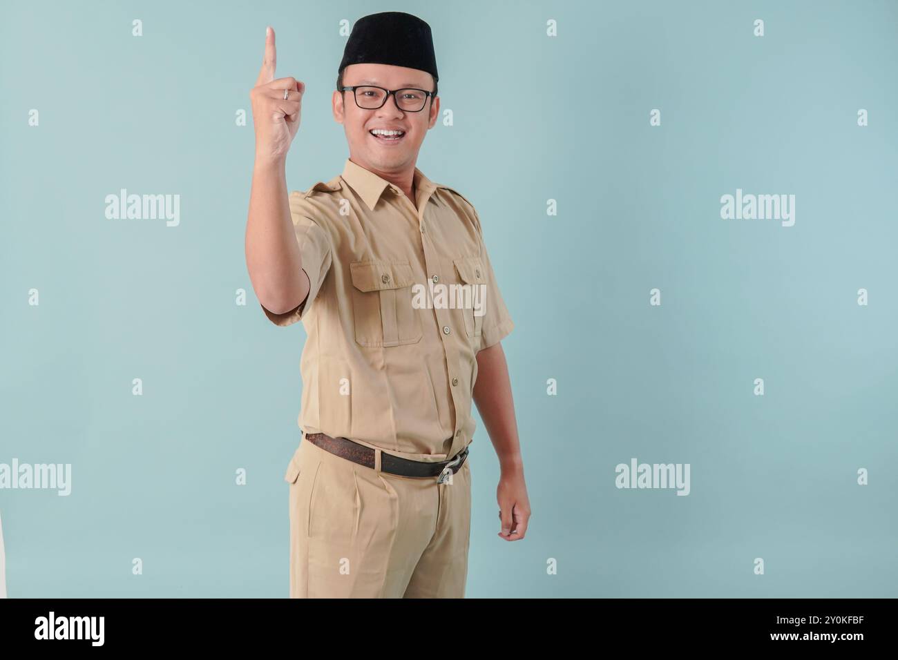 Excited Indonesian government worker man wearing khaki uniform giving ...