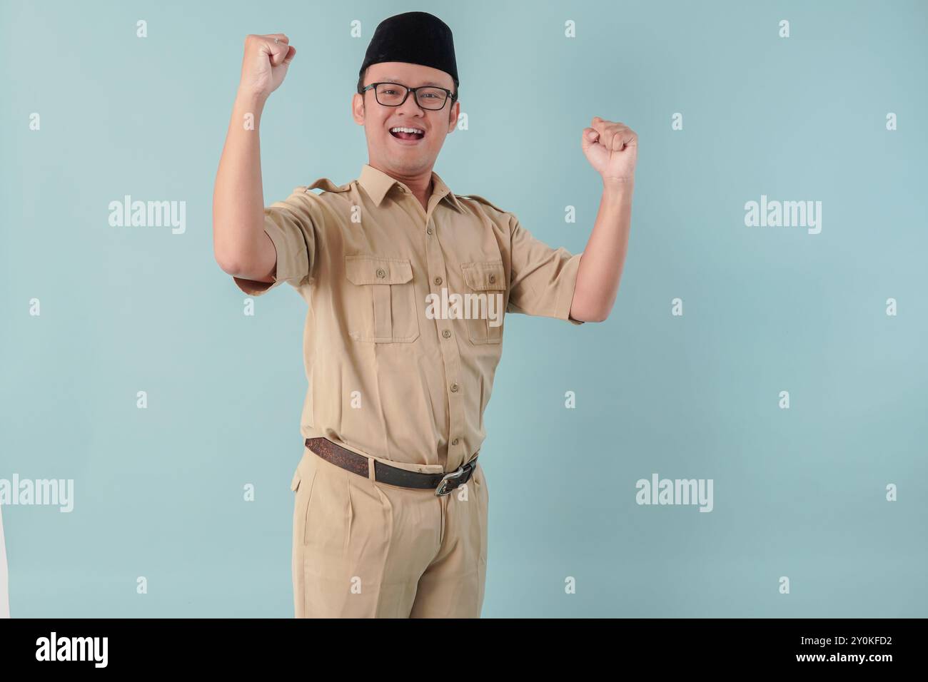 Excited Indonesian government worker man wearing khaki uniform posing ...