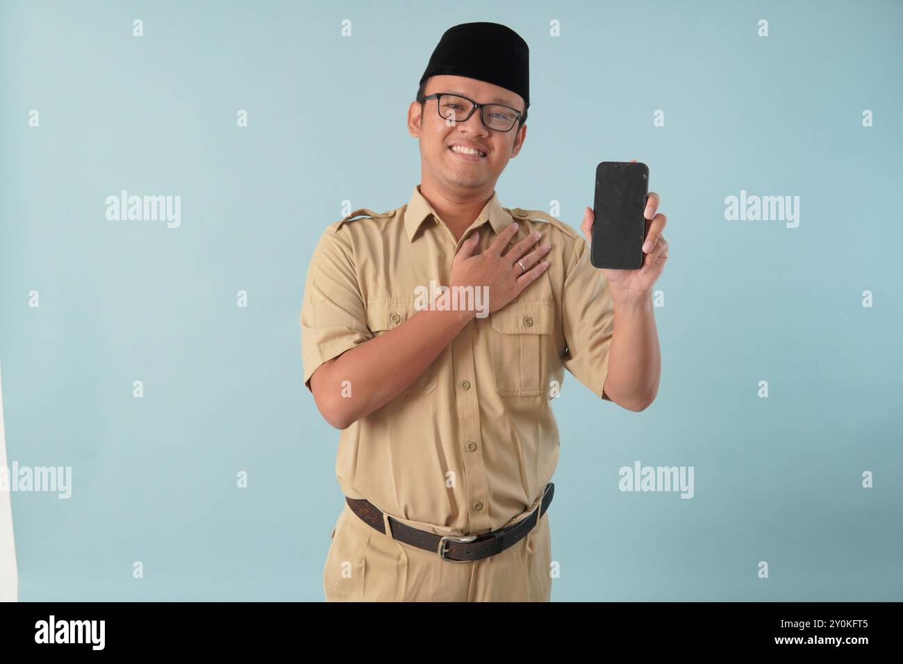 Happy mindful thankful Indonesian government worker man hand on chest ...