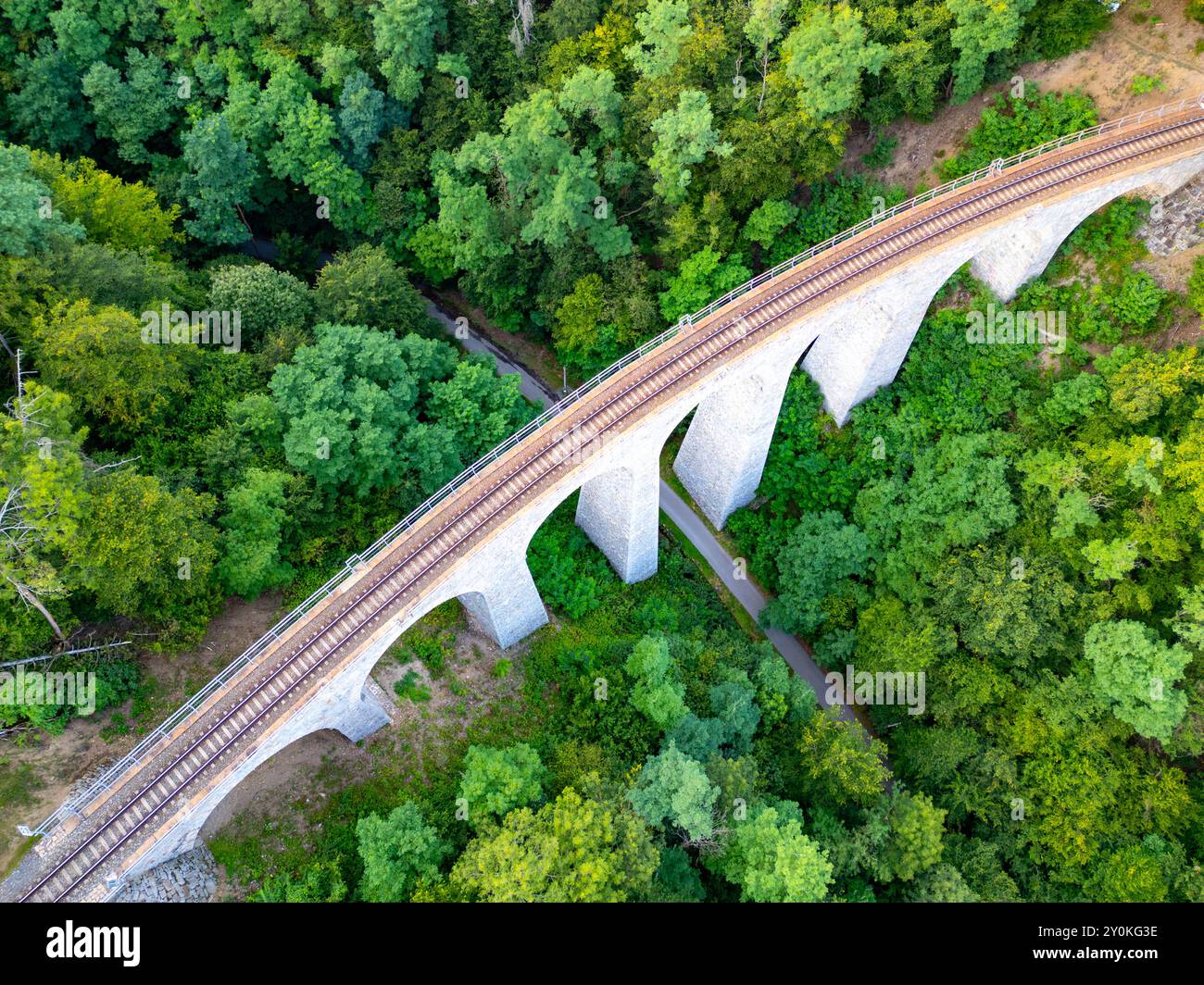 The Zampach stone railway bridge arches gracefully over lush green ...