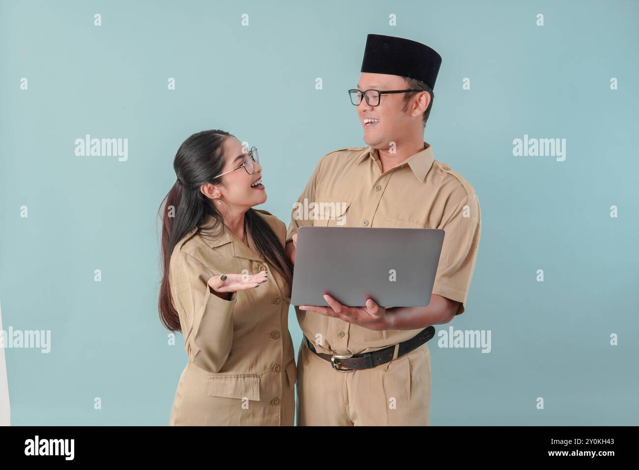 Happy Indonesian government worker couple wearing khaki uniform and ...