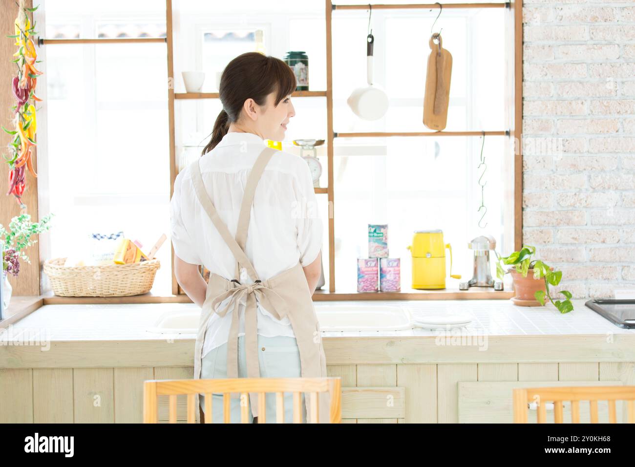Housewife wearing an apron in the kitchen Stock Photo - Alamy