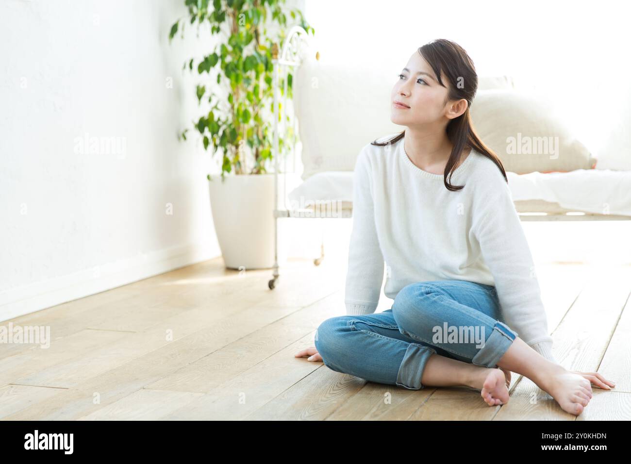 Refreshing woman relaxing in a room Stock Photo - Alamy