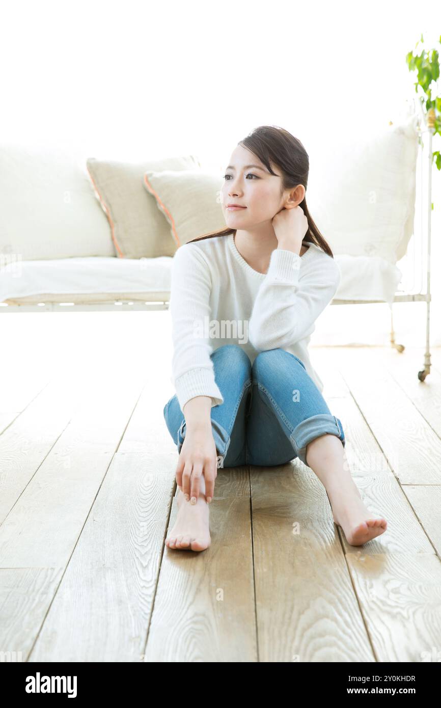 Refreshing woman relaxing in a room Stock Photo - Alamy