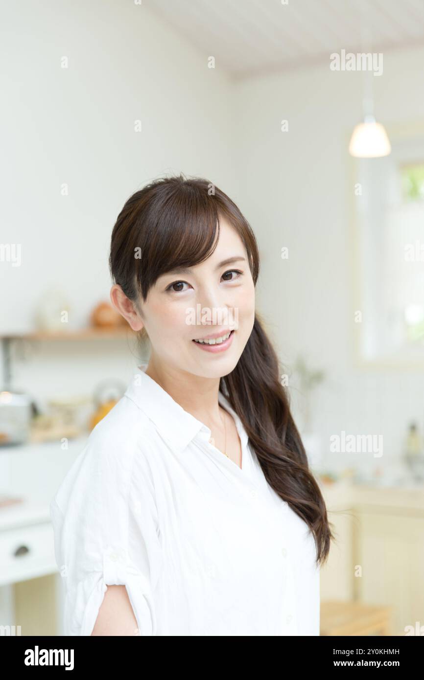 Refreshing woman relaxing in a room Stock Photo - Alamy