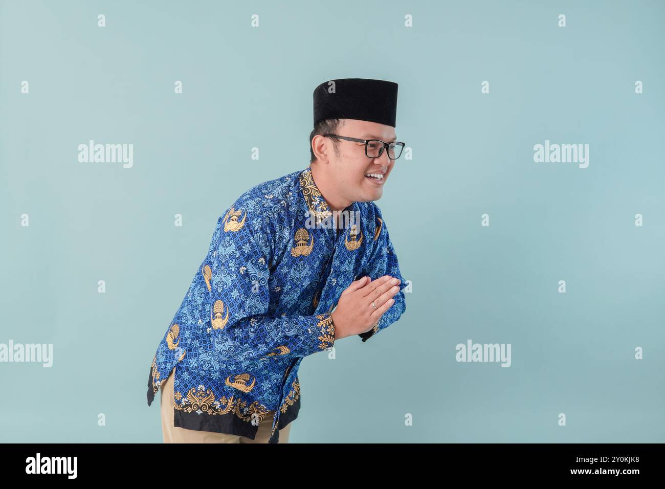 Cheerful Indonesian government worker man wearing blue batik uniform ...