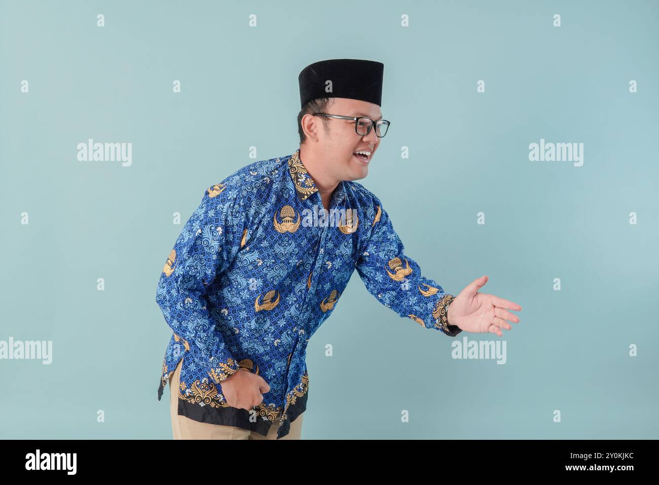 Smiling Indonesian government worker man wearing blue batik uniform ...
