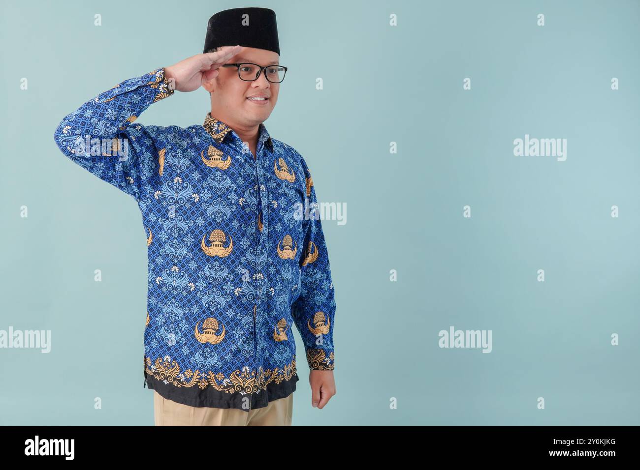 Indonesian government worker man wearing blue batik uniform doing ...