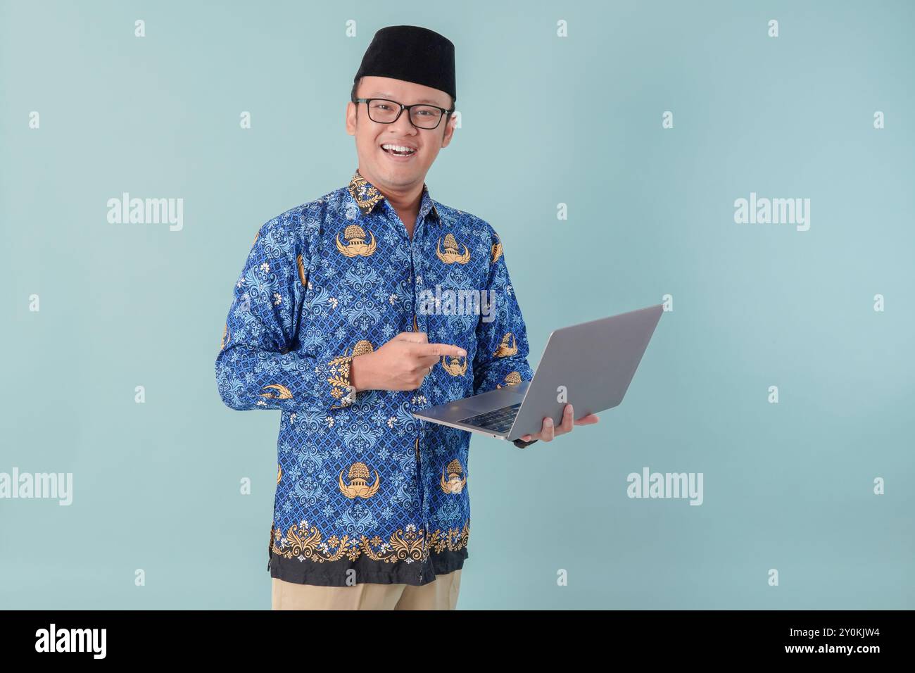 Happy Indonesian government worker men wearing blue batik uniform ...