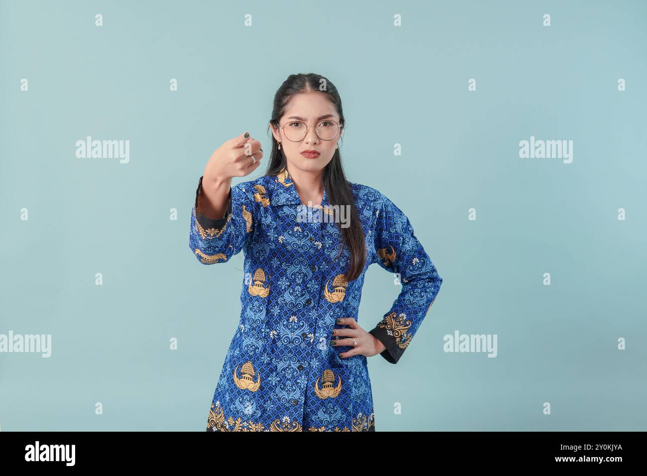 Angry government worker woman wearing blue batik uniform and glasses ...