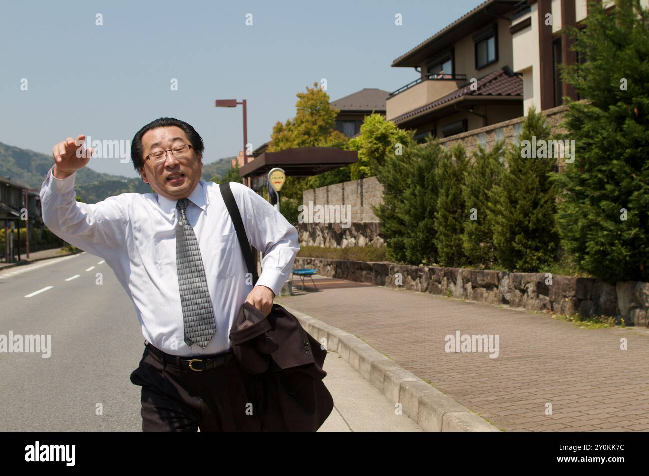 Obese middle-aged man chasing the bus Stock Photo - Alamy